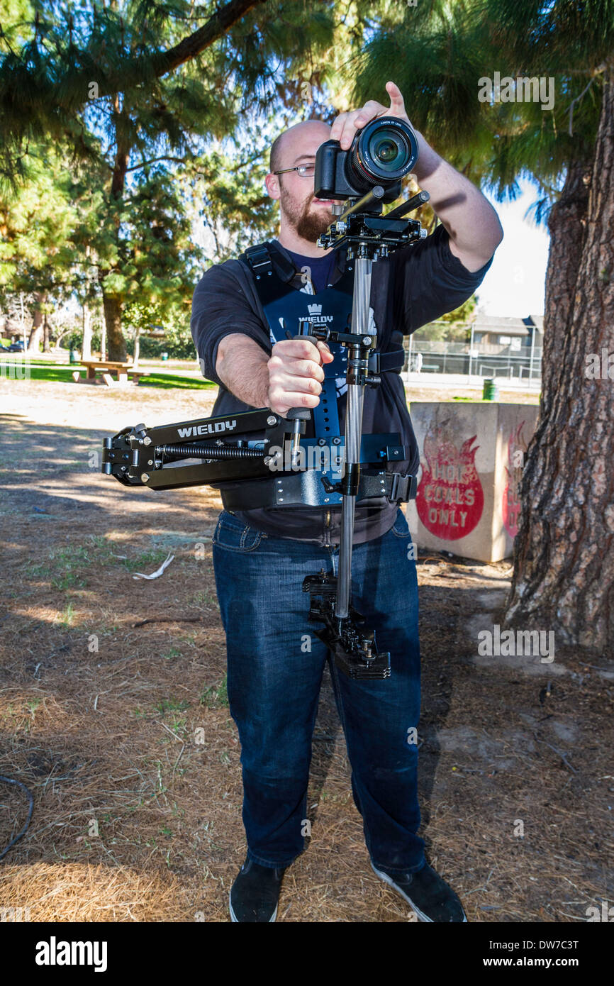 A young man with a DSLR steadycam rig Stock Photo - Alamy