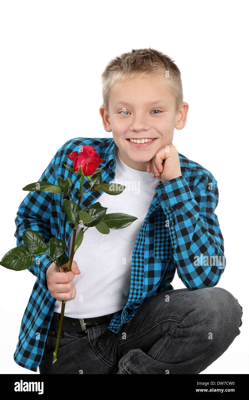 Young boy with a rose on Valentine's Day isolated on white background ...