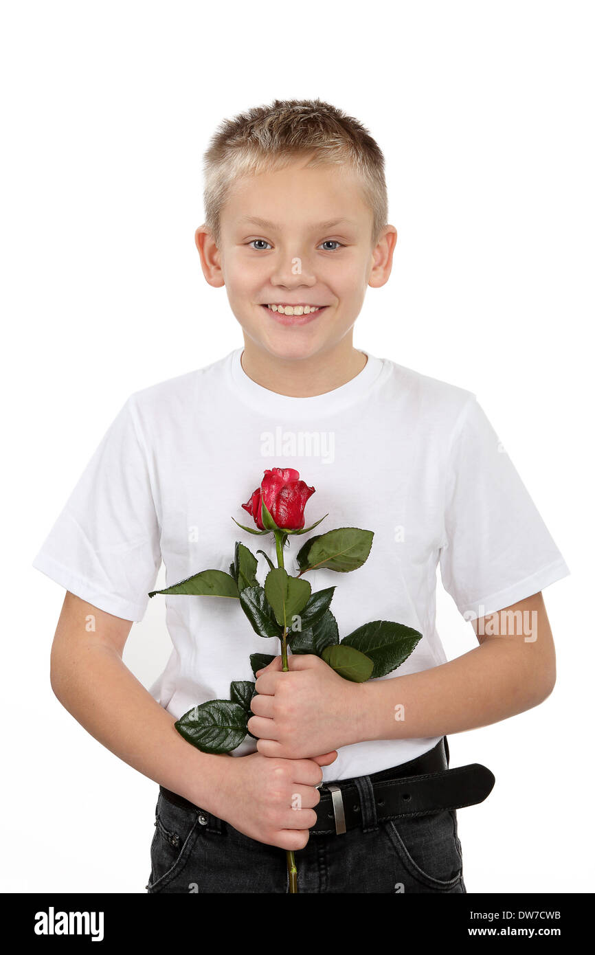 Young boy with a rose on Valentine's Day isolated on white background ...