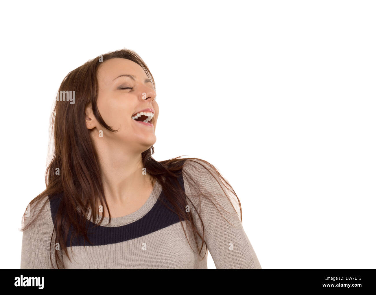 Attractive young woman enjoying a good laugh with her head thrown back ...