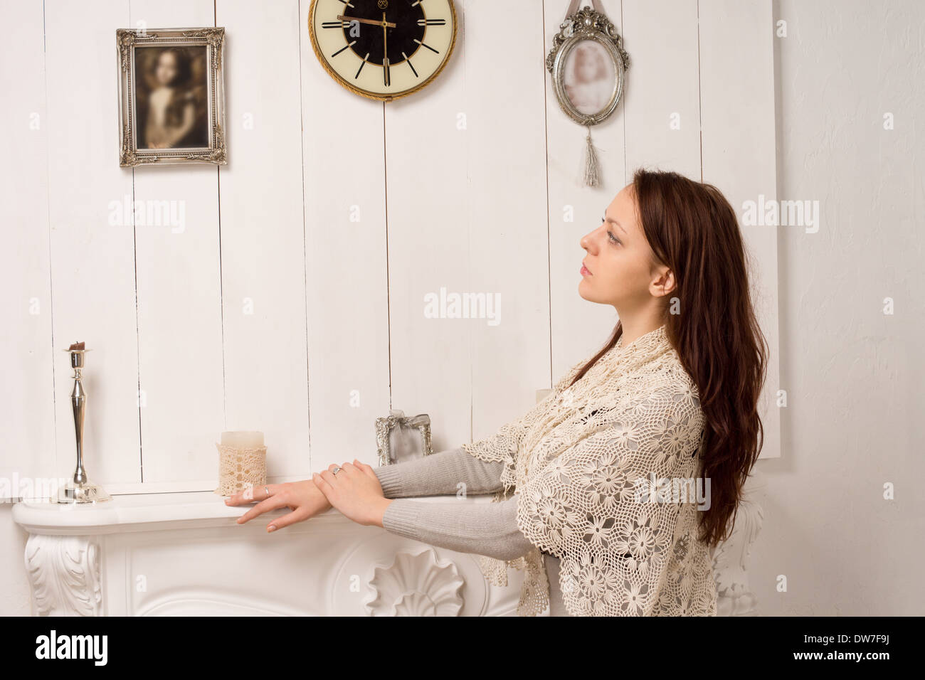 Nostalgic woman looking at an old family portrait Stock Photo - Alamy