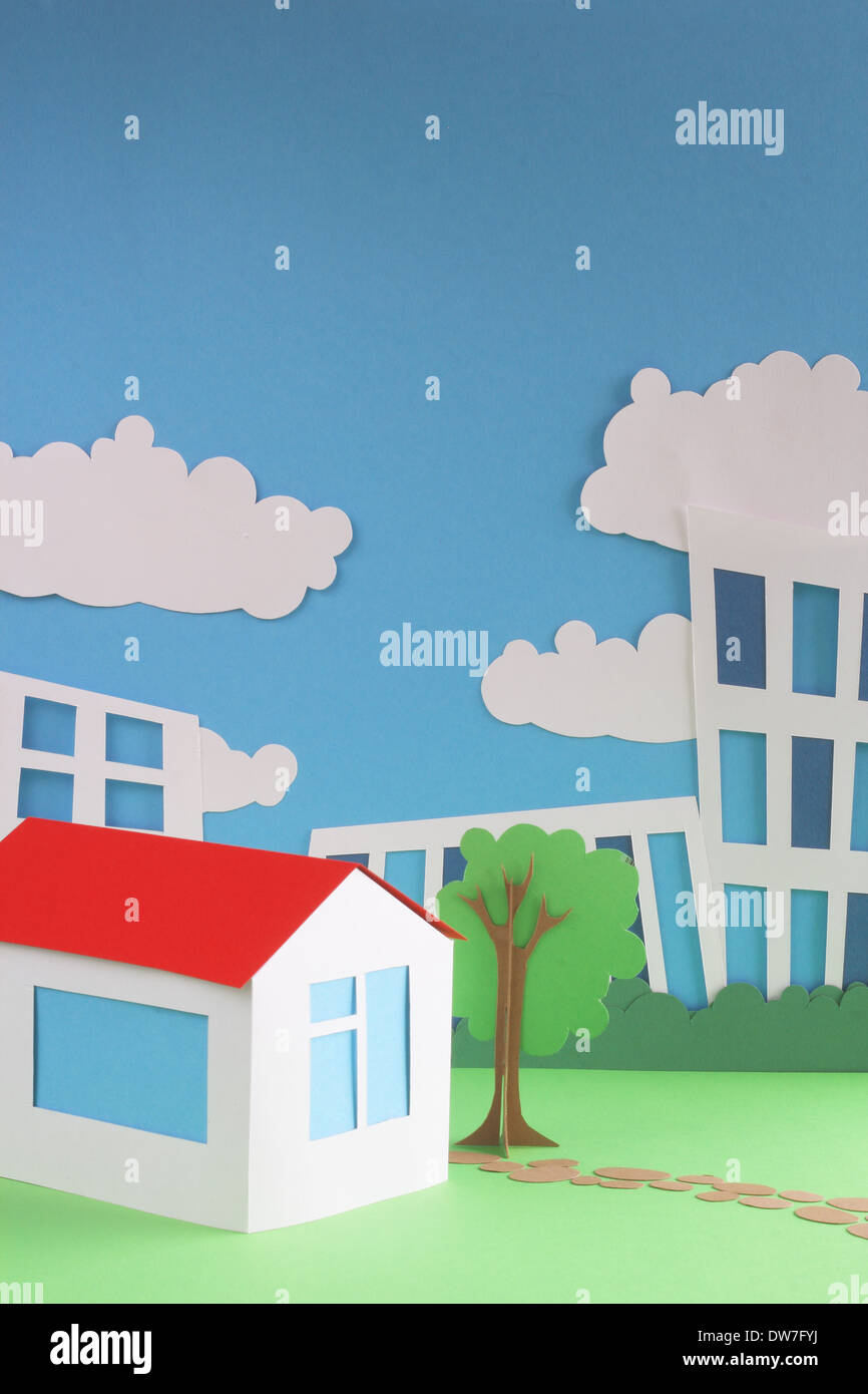 Paper cottage over city background real estate concept Stock Photo - Alamy