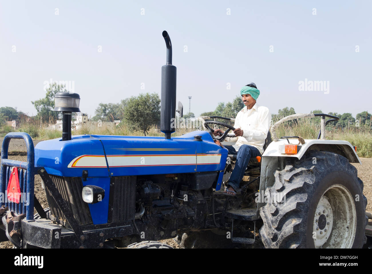 1 indian farmer driving tractor Stock Photo - Alamy