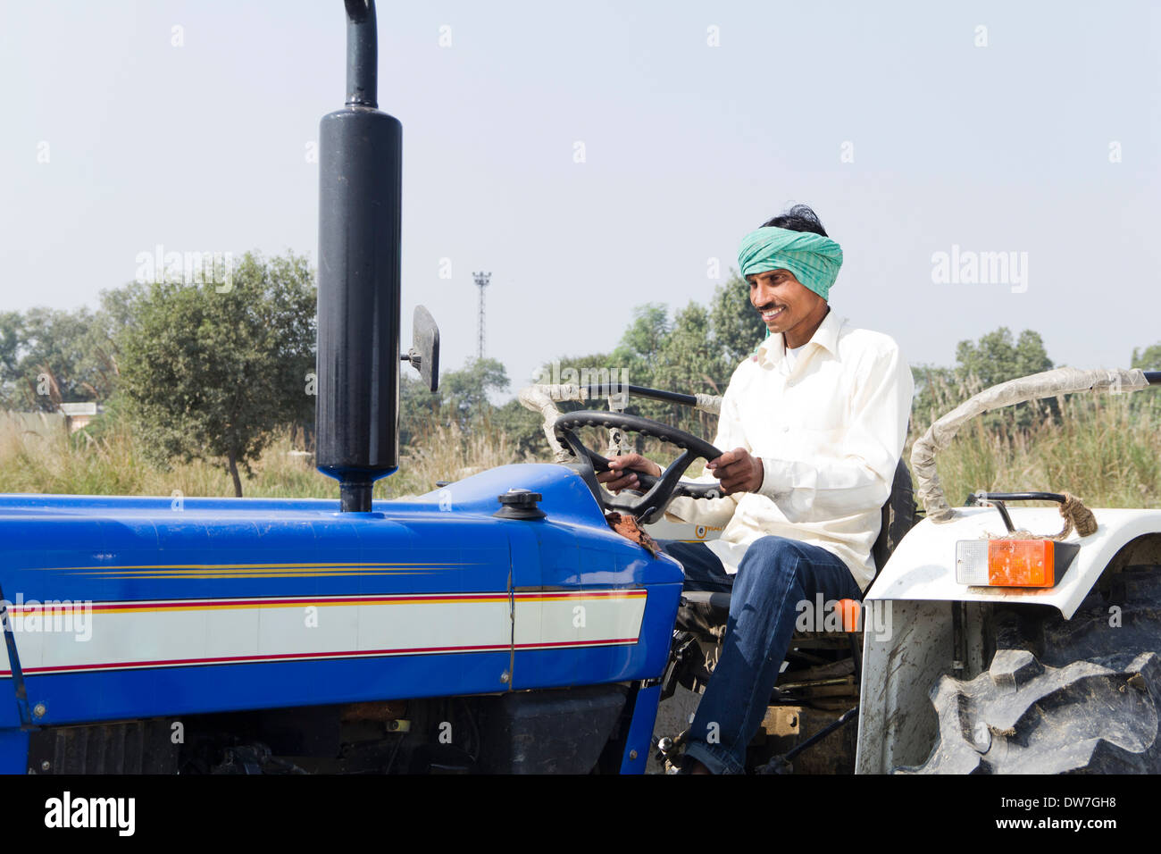1 indian farmer driving tractor Stock Photo - Alamy