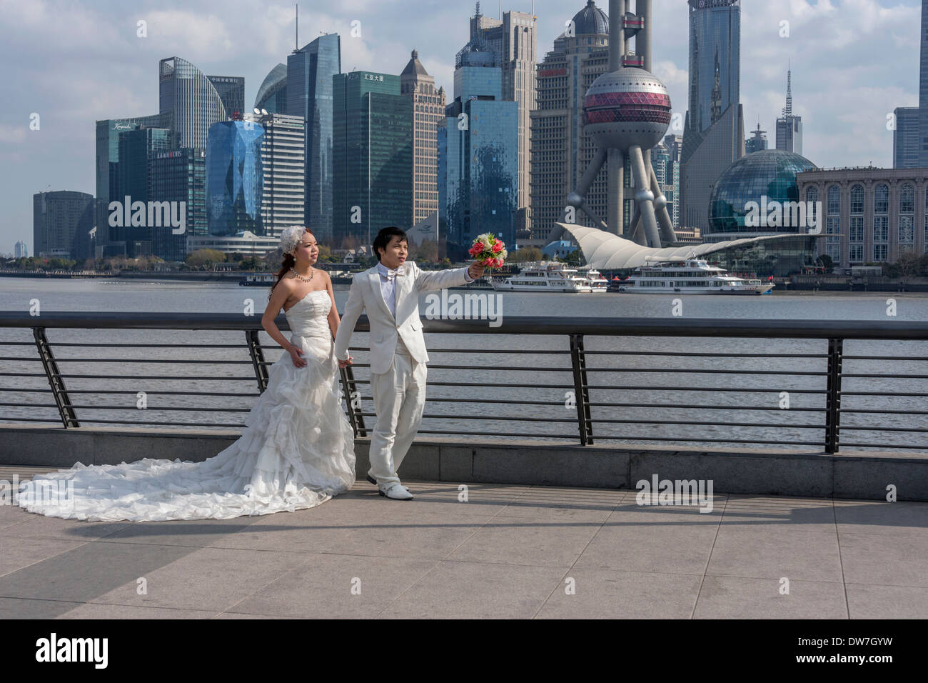 Wedding couple posing against the Pudong skyline, The Bund, Shanghai ...