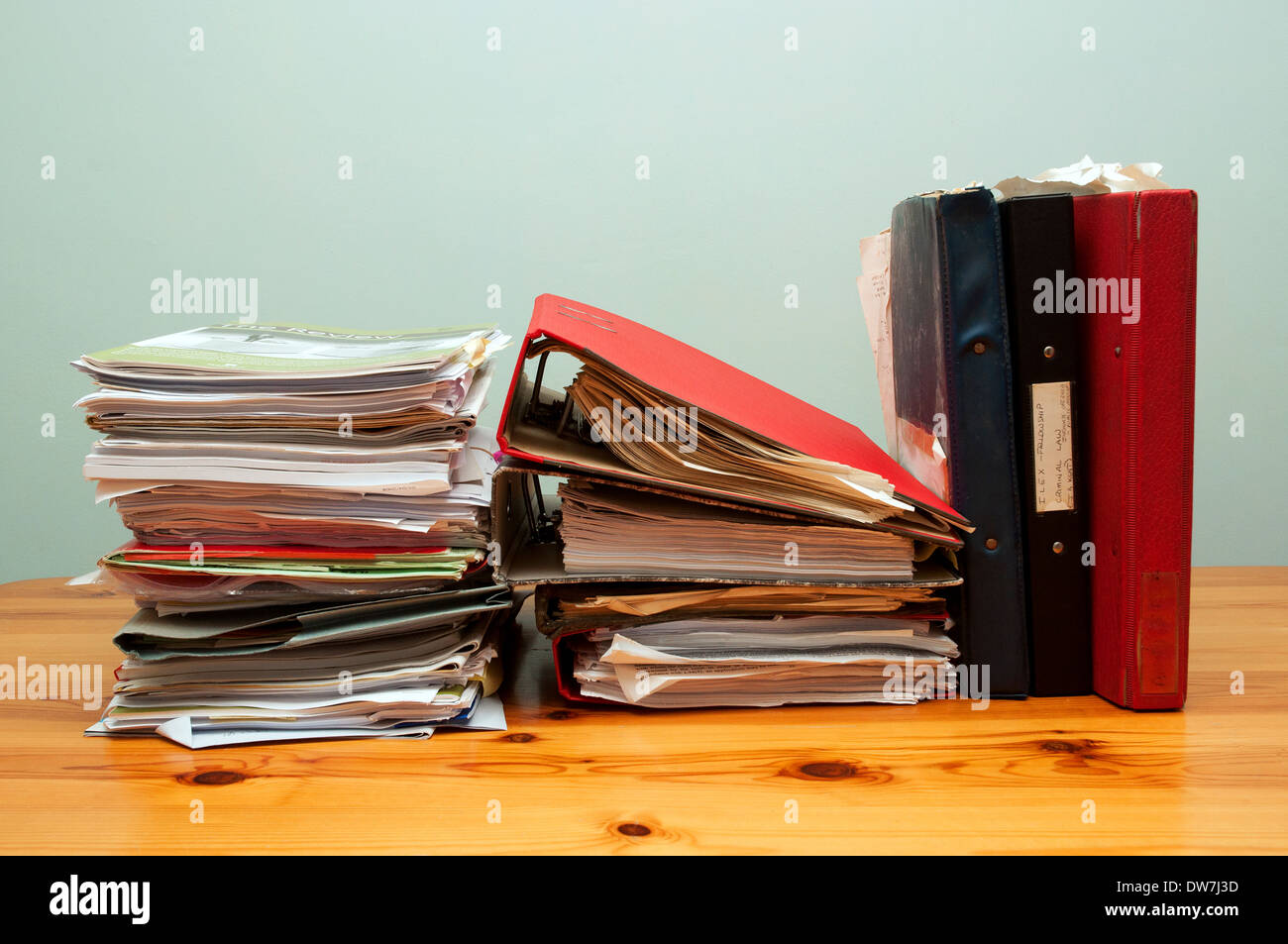 a pile of office files and paperwork on a desk Stock Photo - Alamy