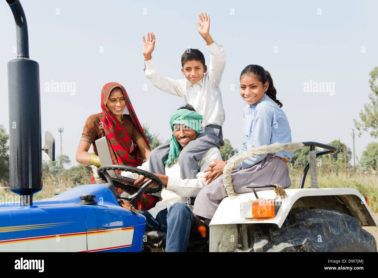 Indian farmer driving tractor with his family Stock Photo - Alamy