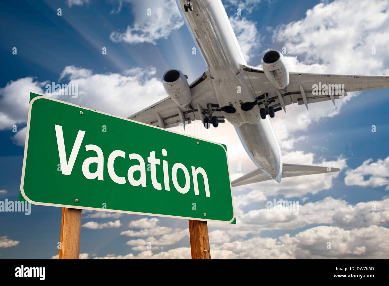 Vacation Green Road Sign and Airplane Above with Dramatic Blue Sky and ...