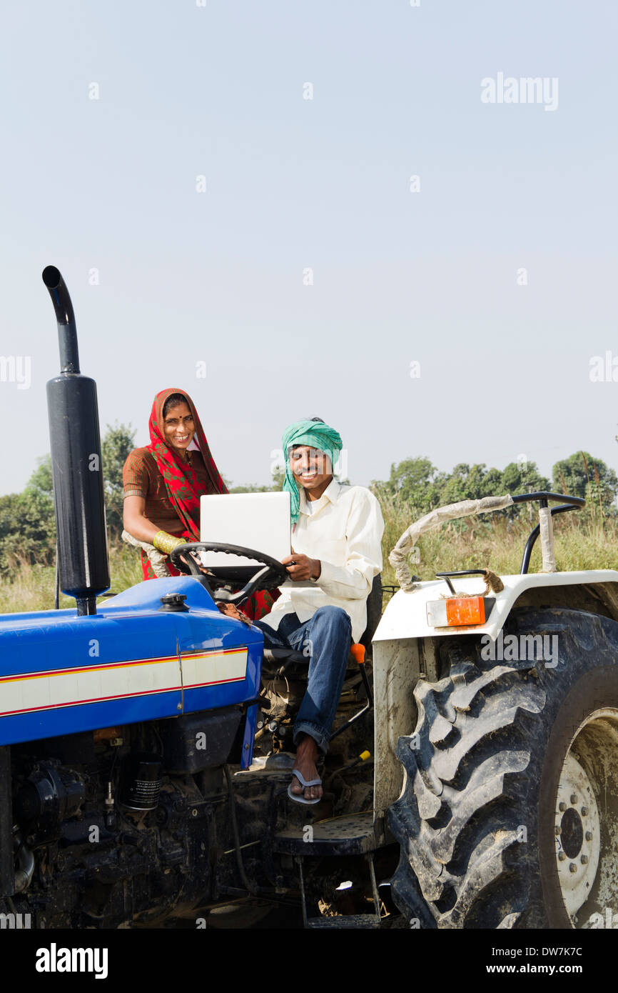Indian farmer driving tractor Stock Photo - Alamy