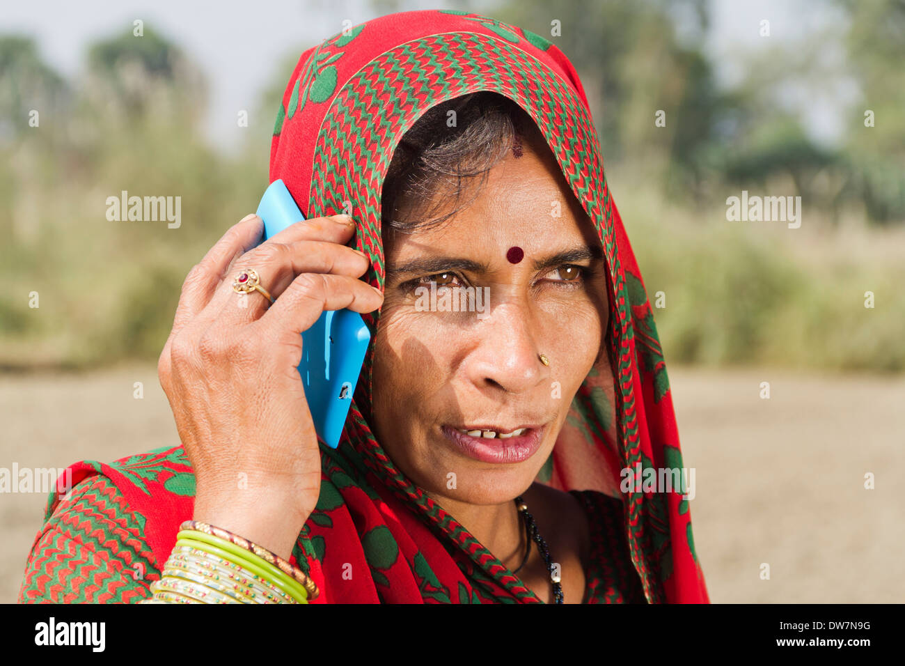 1 Indian woman talking with mobile Stock Photo - Alamy