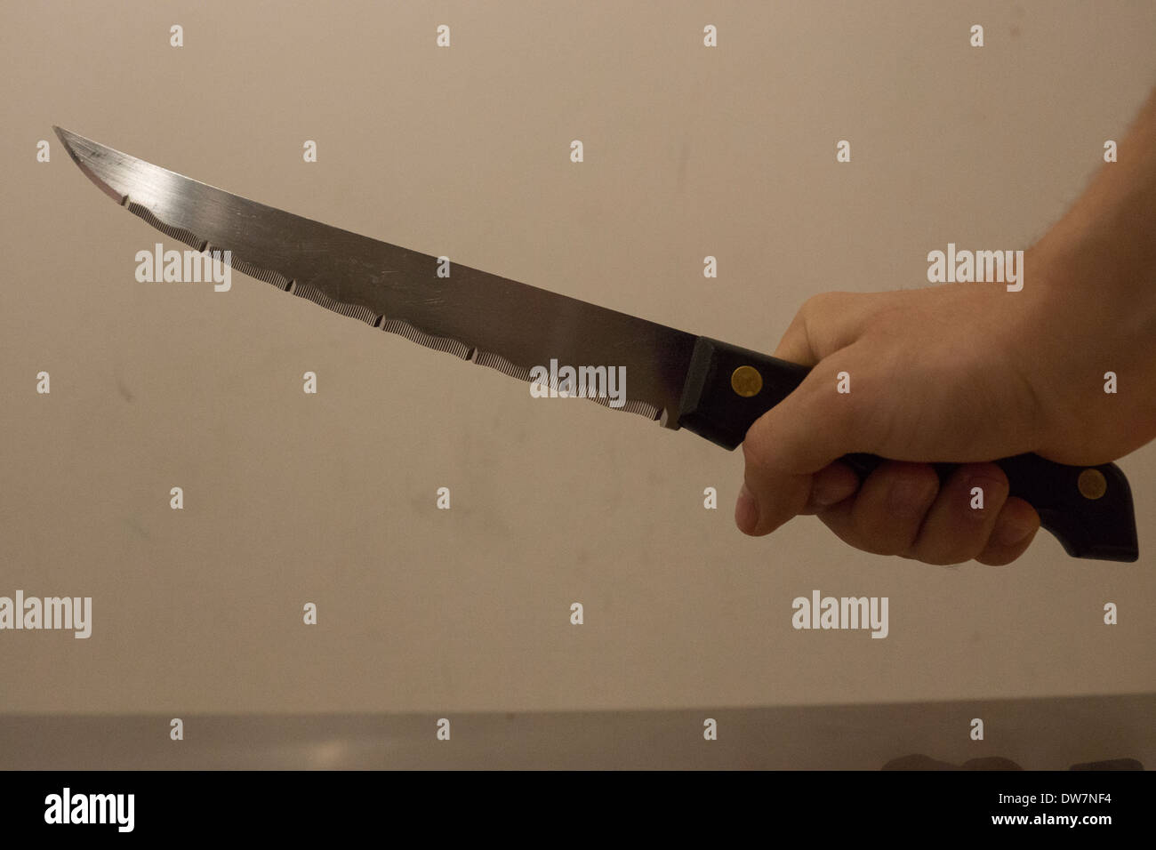 kitchen Knife teenager hand long sharp blade Stock Photo - Alamy