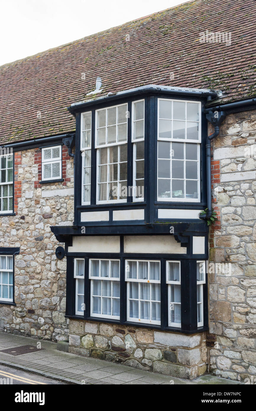 Traditional black and white wooden bay window in stone cottage in ...
