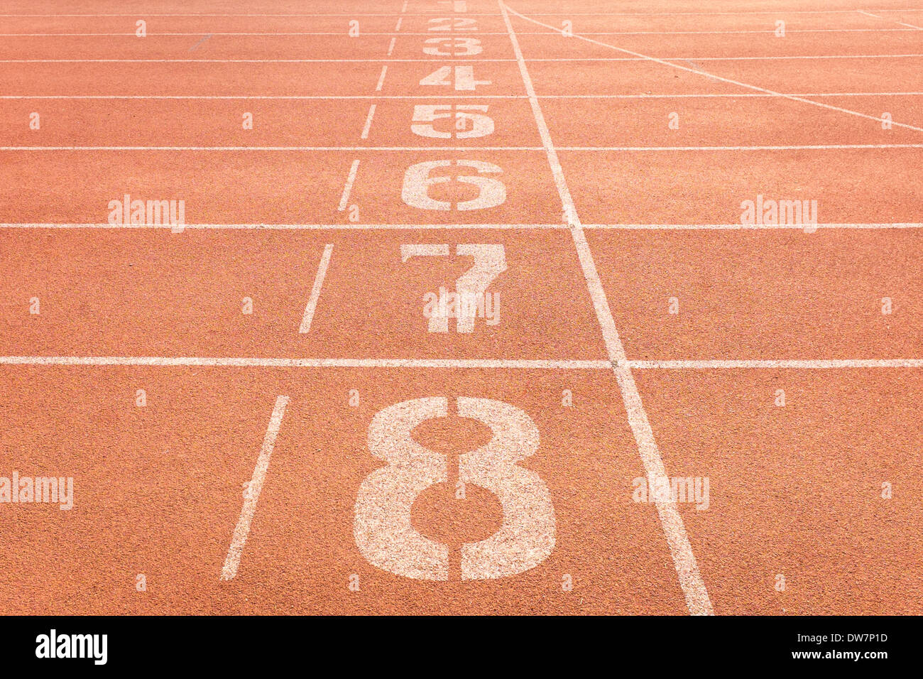 red color and texture of athletics track lanes with white line and ...