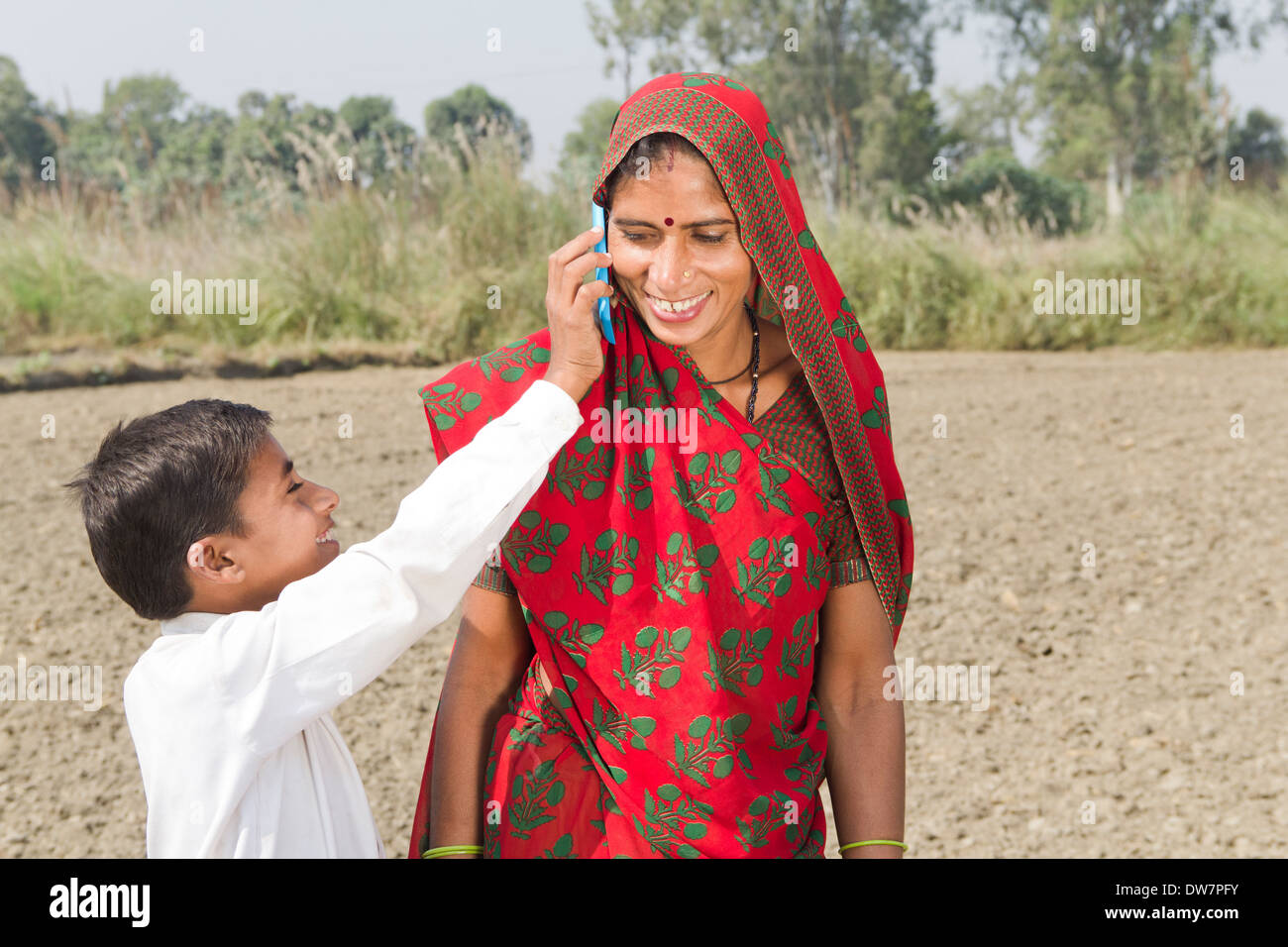 Indian woman standing with kid and talking Stock Photo - Alamy