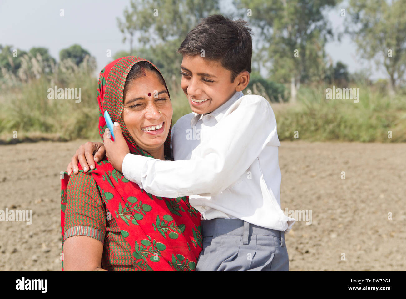 Indian woman standing with kid and talking Stock Photo - Alamy
