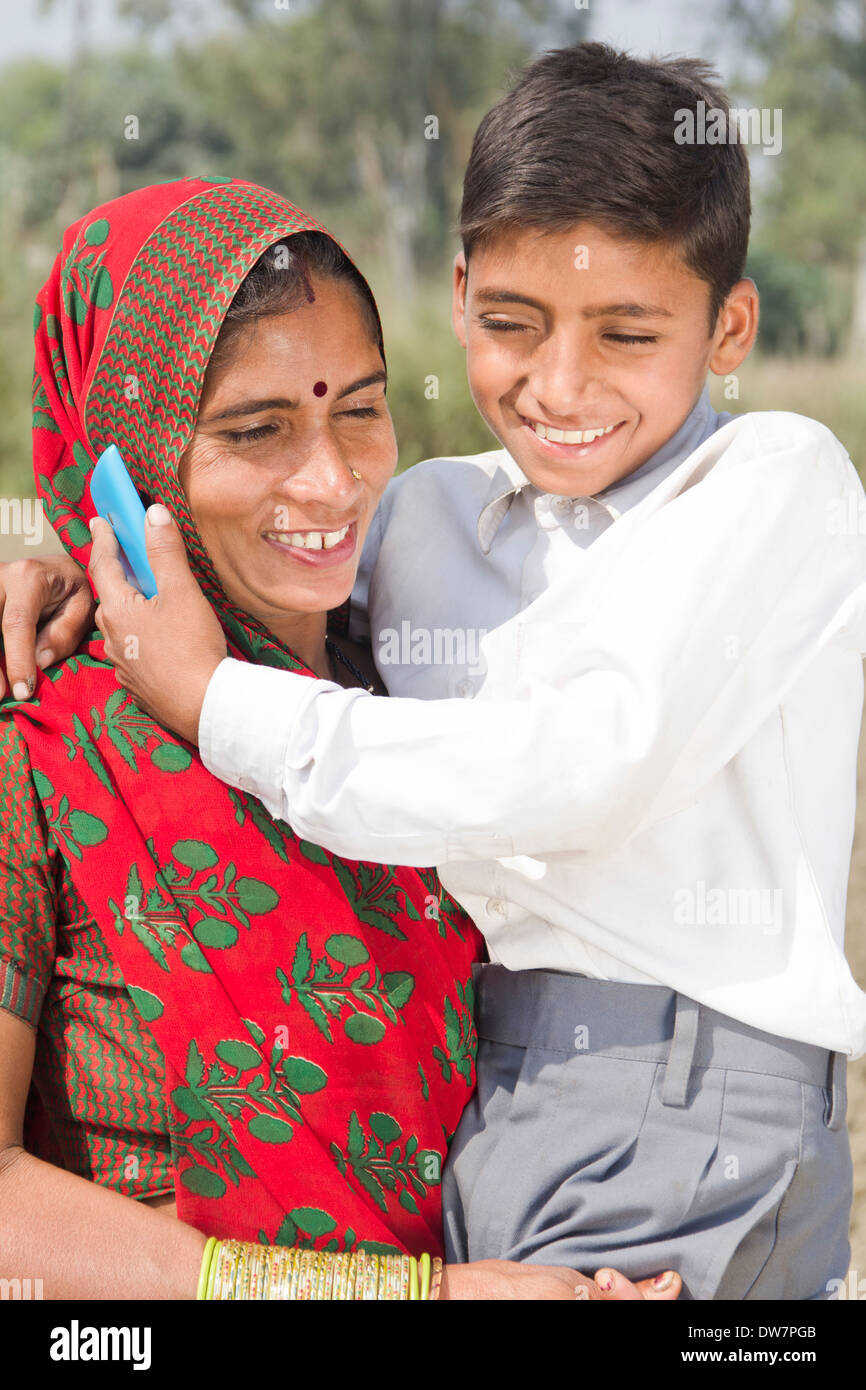 Indian woman standing with kid and talking Stock Photo - Alamy