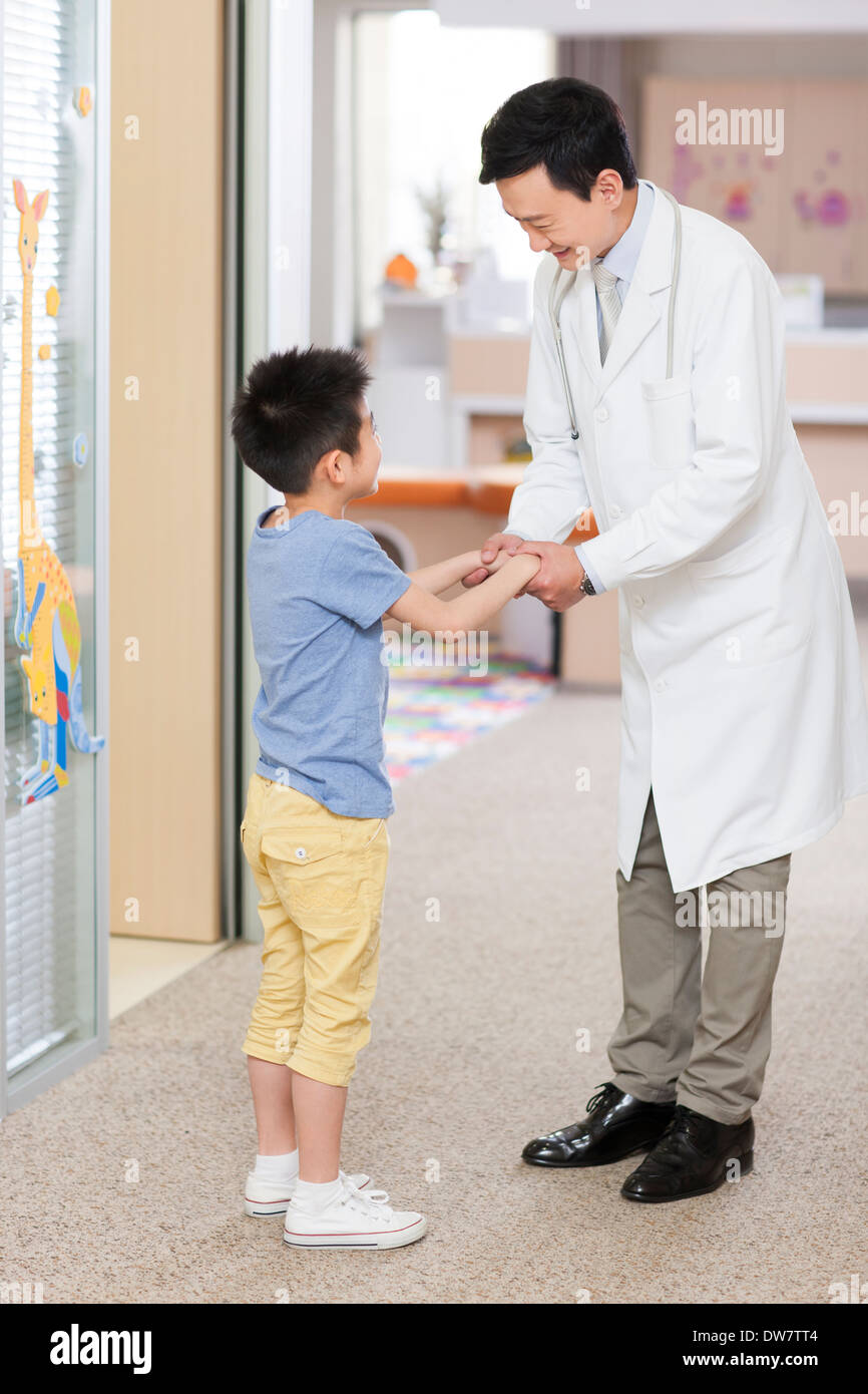 Smiling doctor holding hands boy hi-res stock photography and images ...