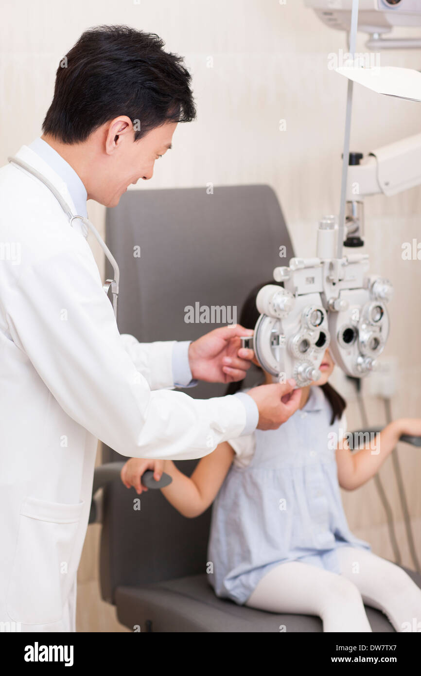 Doctor examining girl's eyes Stock Photo - Alamy