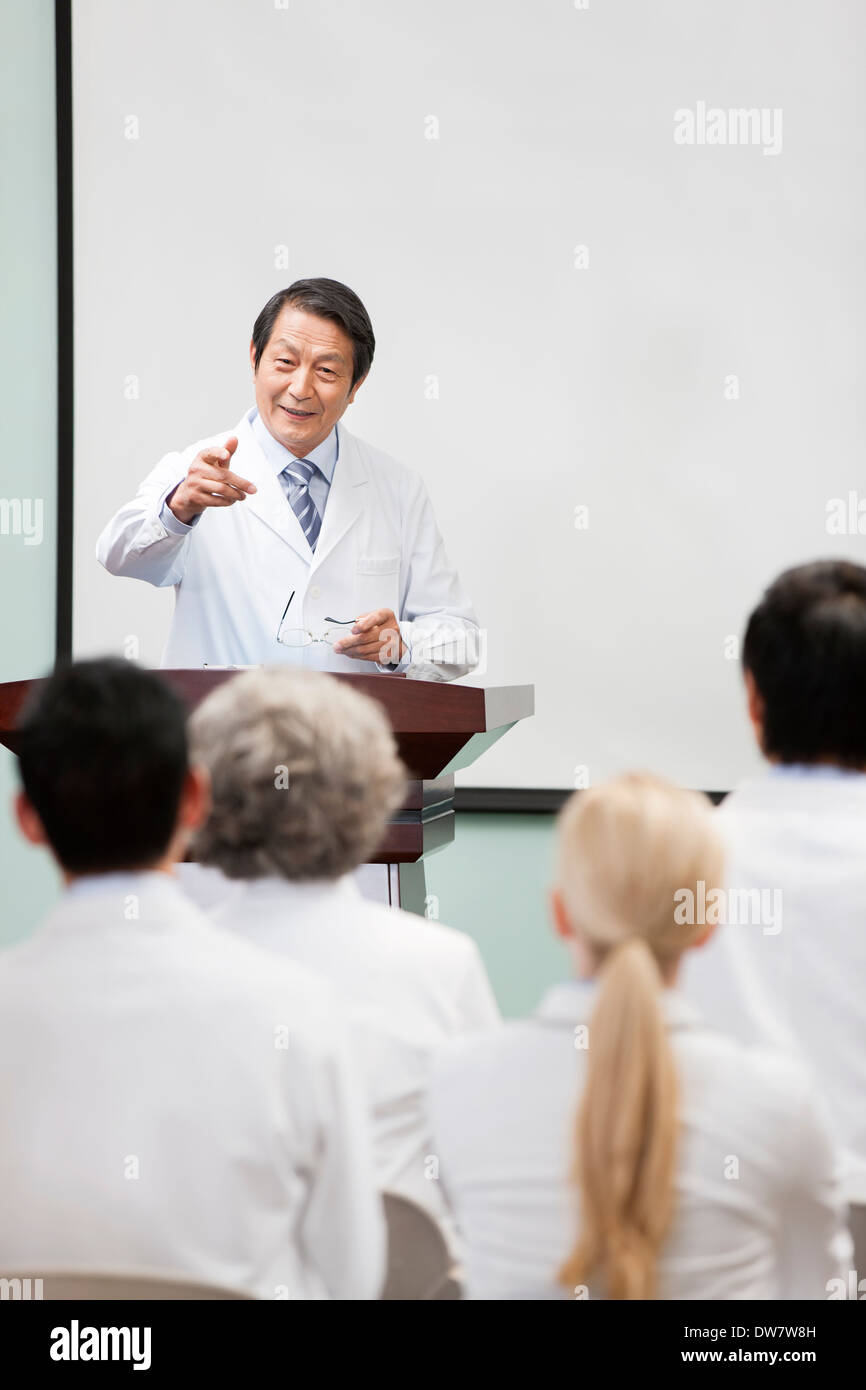 Senior doctor giving speech in boardroom Stock Photo - Alamy