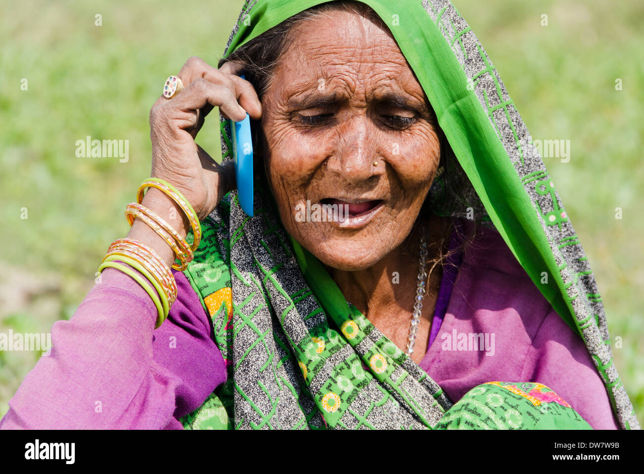 1 Indian old woman talking with mobile Stock Photo - Alamy