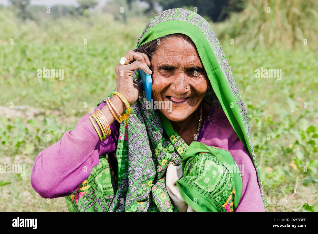 1 Indian old woman talking with mobile Stock Photo - Alamy