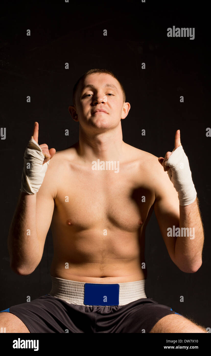 Confident young boxer making a derogatory gesture at his opponent ...