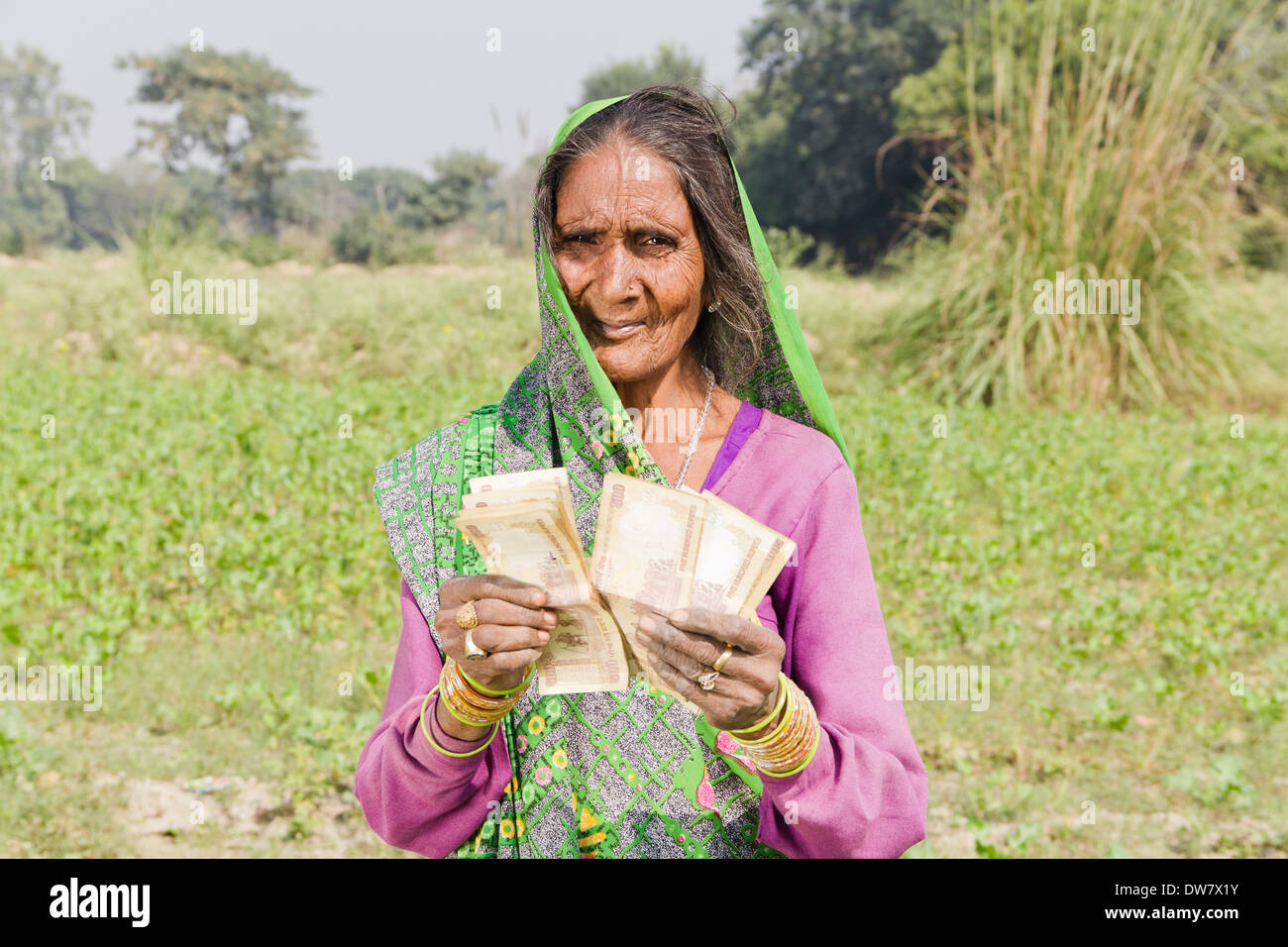 Poor woman counting money outside hi-res stock photography and images ...