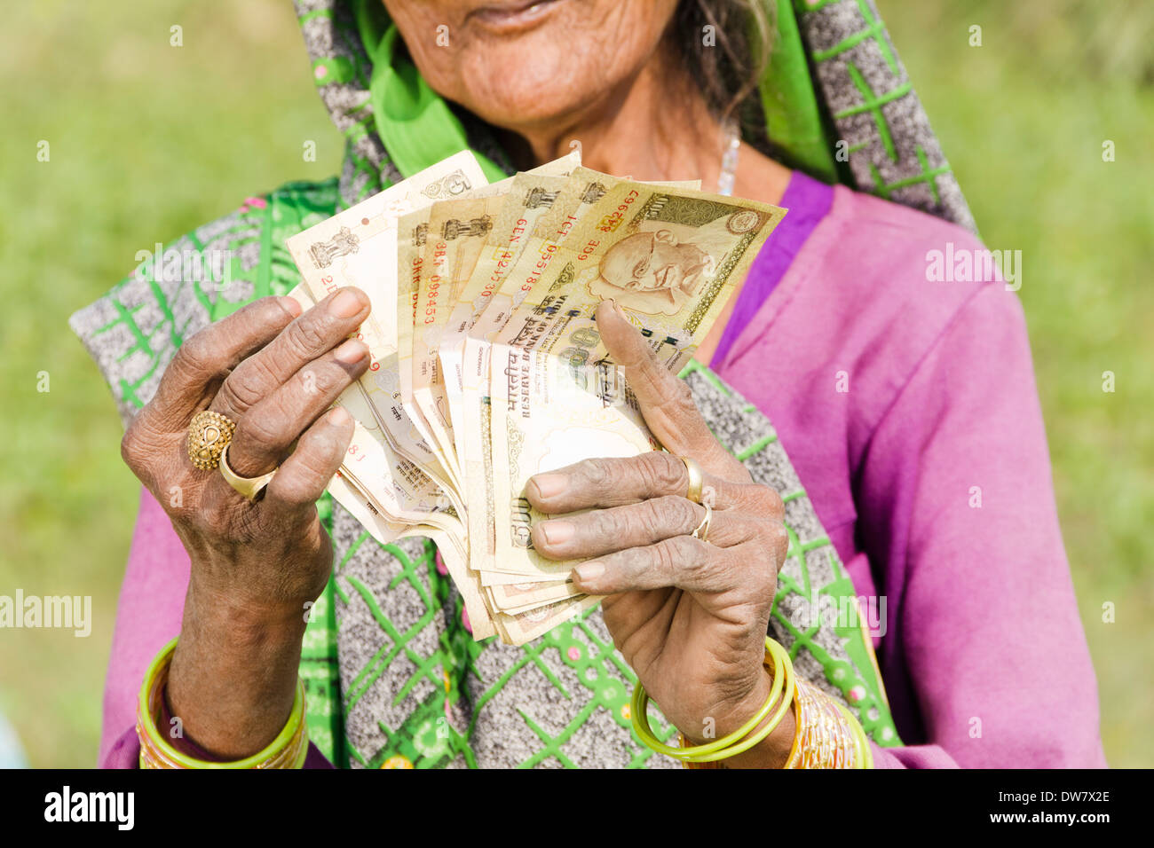 Poor woman counting money outside hi-res stock photography and images ...