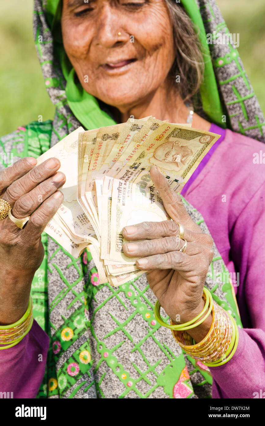 Poor woman counting money outside hi-res stock photography and images ...