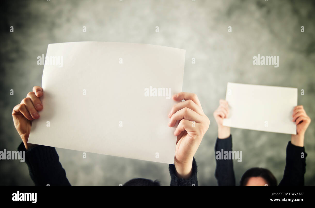 Two women holding blank paper above their heads Stock Photo - Alamy