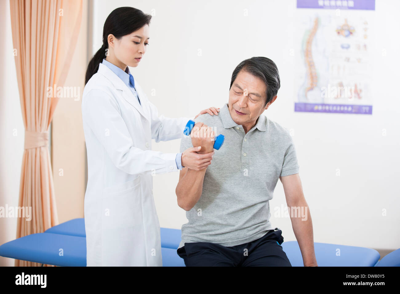 Senior patient exercising with dumbbell under doctor's help Stock Photo ...