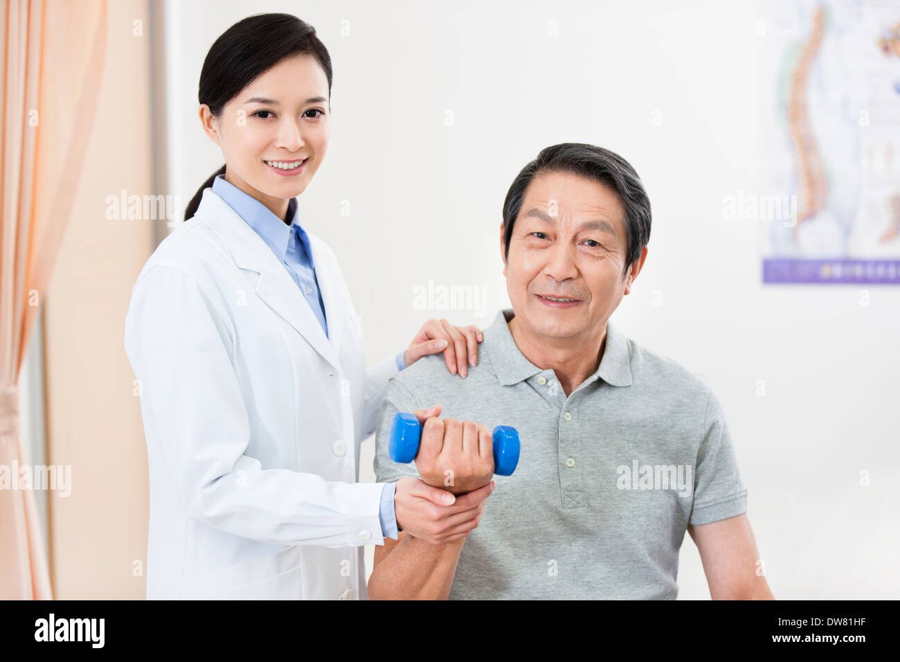 Senior patient exercising with dumbbell under doctor's help Stock Photo ...