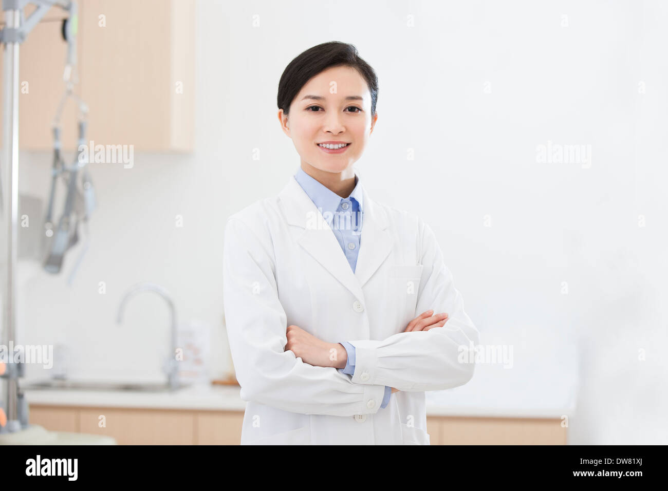 Confident female doctor with arms crossed Stock Photo - Alamy