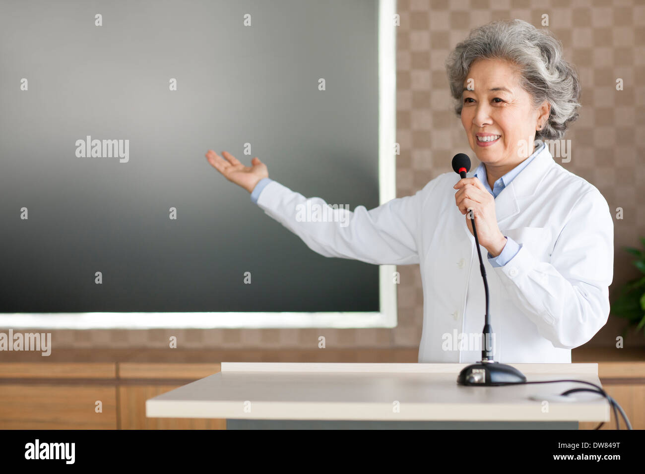 Senior female doctor giving a speech Stock Photo - Alamy