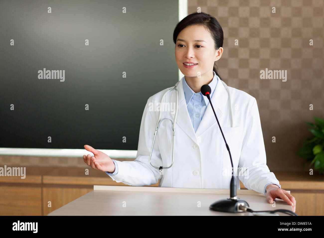 Female doctor giving a speech Stock Photo - Alamy