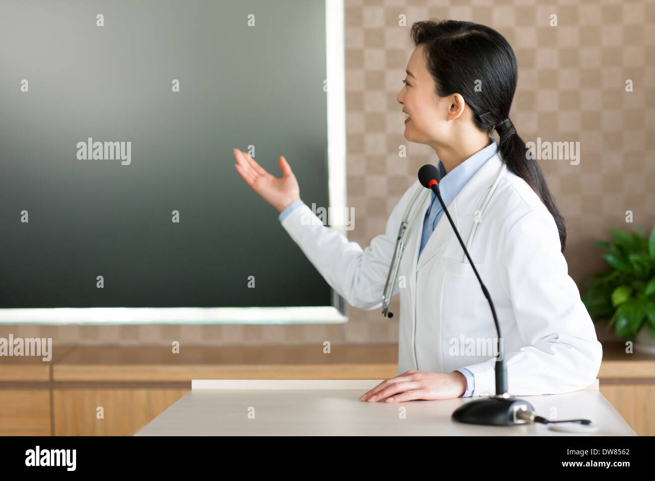 Female doctor giving a speech Stock Photo - Alamy