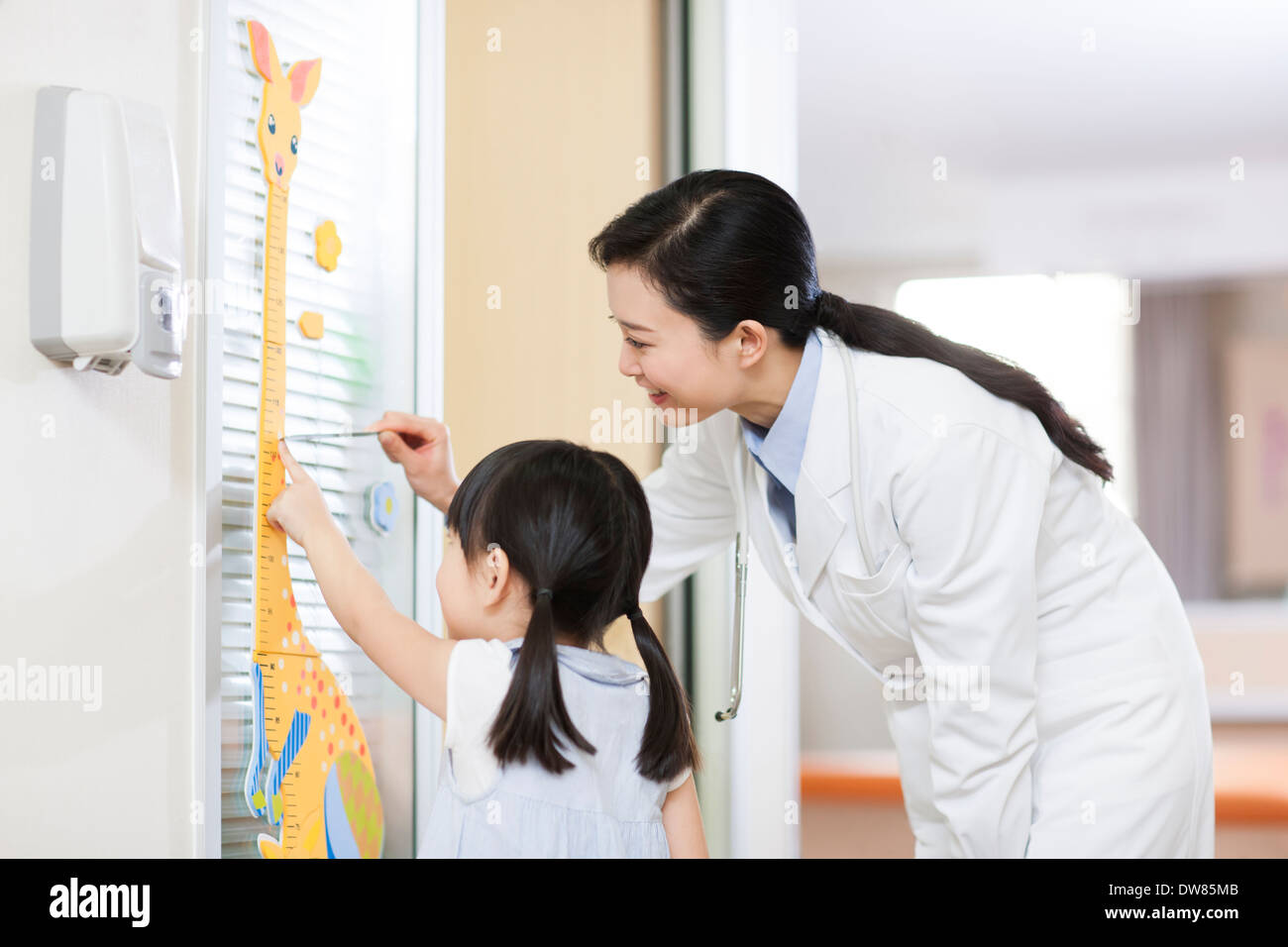 Doctor measuring girl's height Stock Photo - Alamy