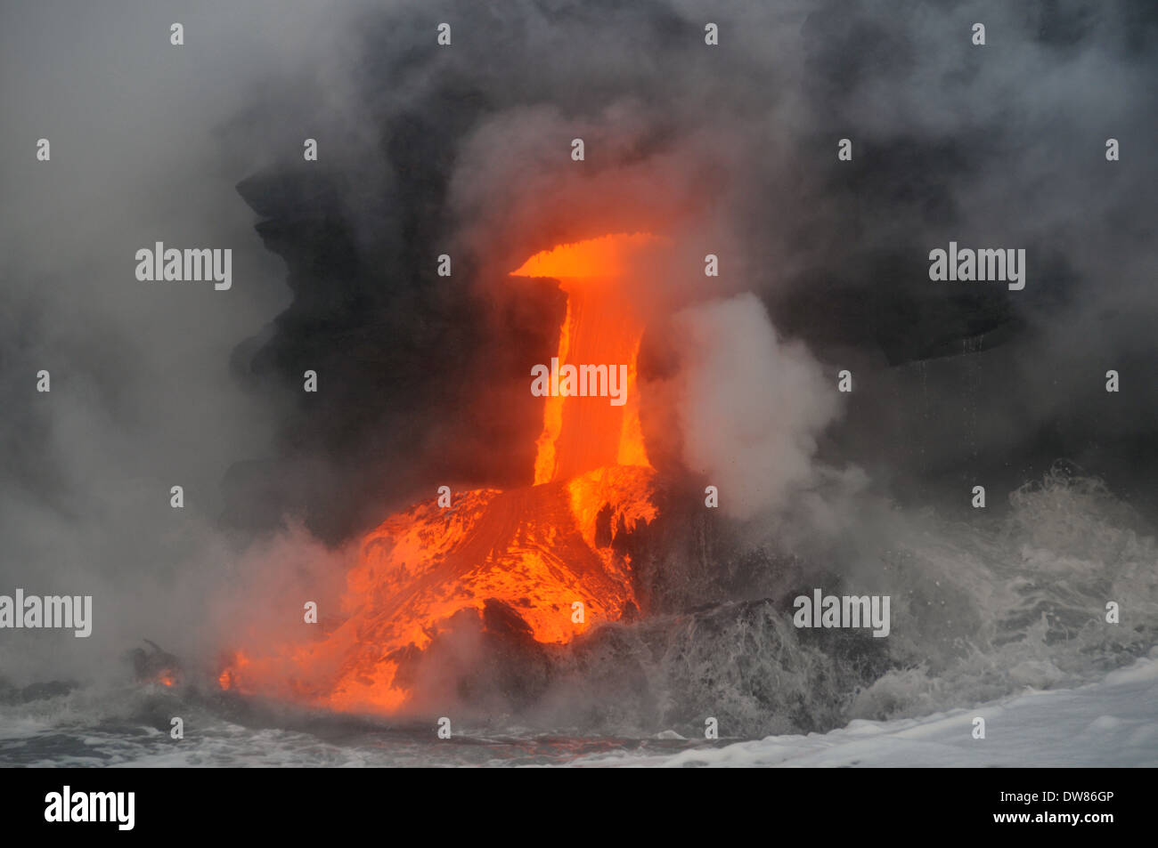 Waves crashing and lava from Kilauea Volcano flowing into the ocean ...