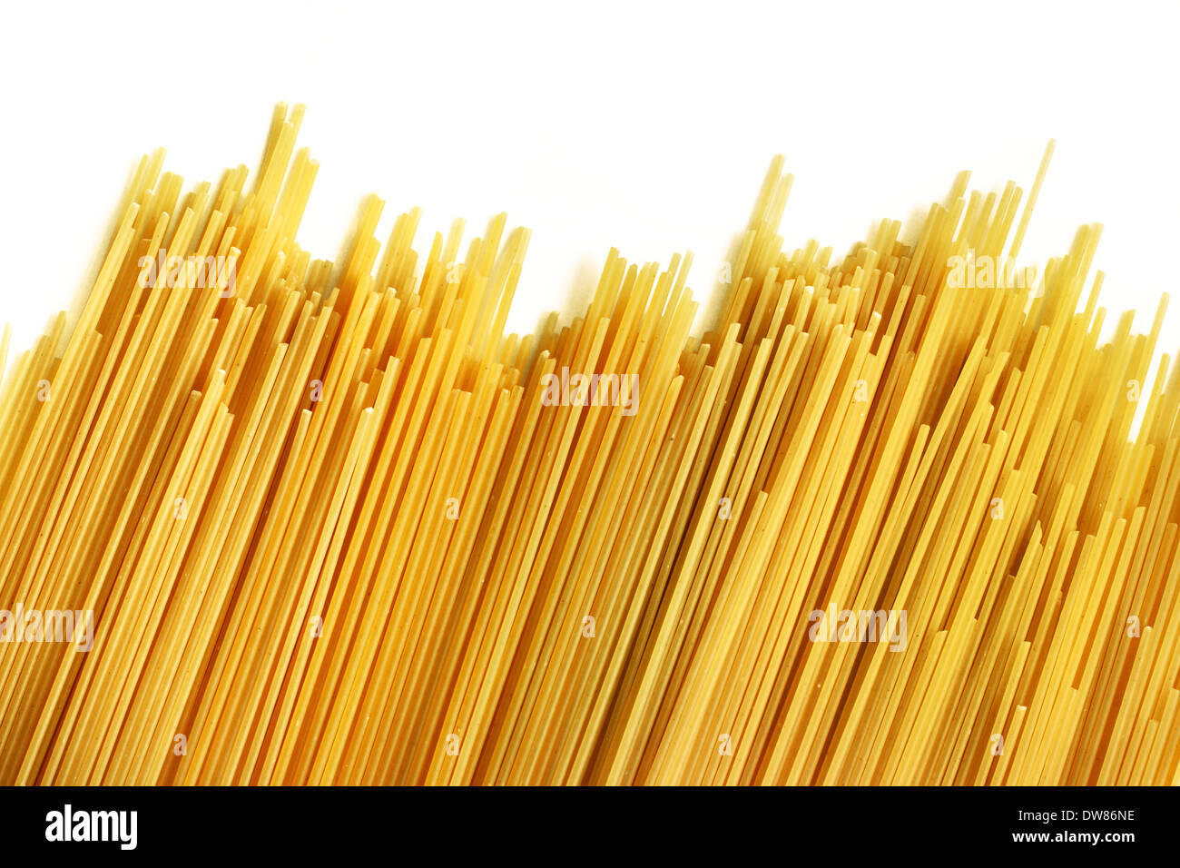 Uncooked Italian spaghetti on a white background Stock Photo - Alamy