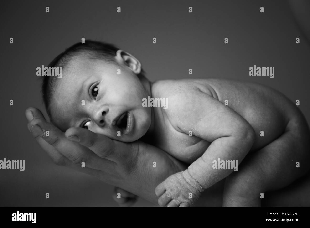 happy newborn baby girl just a week old photographed in the studio ...