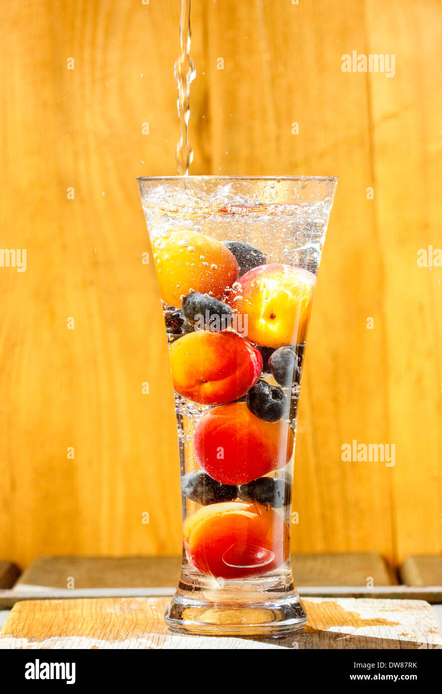Fresh fruits in glass of water. Refreshment on sunny summer day.Fresh ...