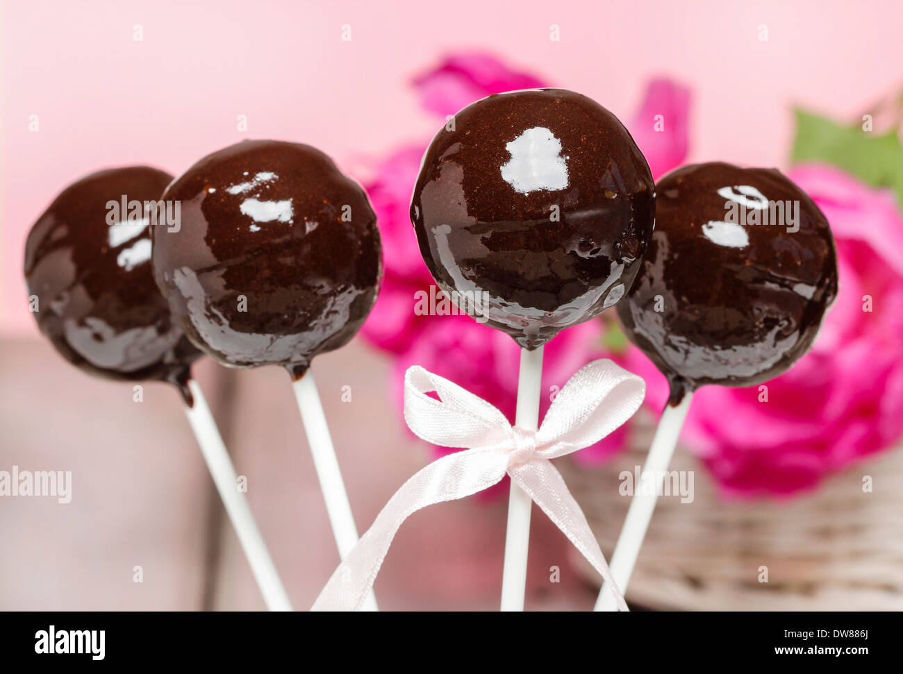 Chocolate cake pops on pink romantic backgroundChocolate cake pops on ...