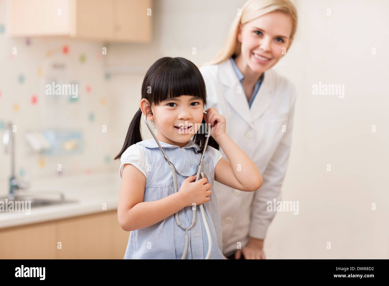 Happy doctor and girl with stethoscope Stock Photo - Alamy