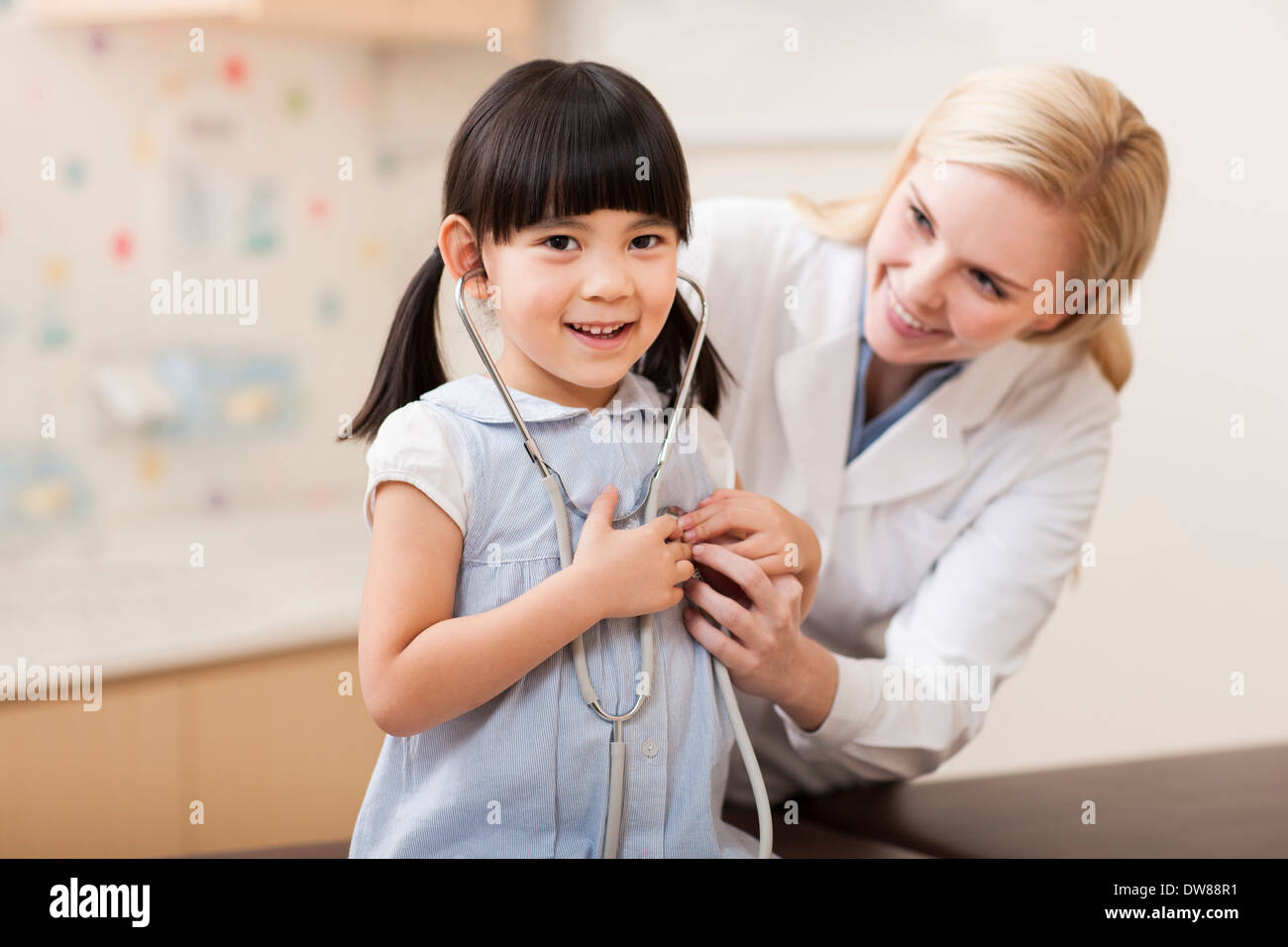 Happy doctor and girl with stethoscope Stock Photo - Alamy