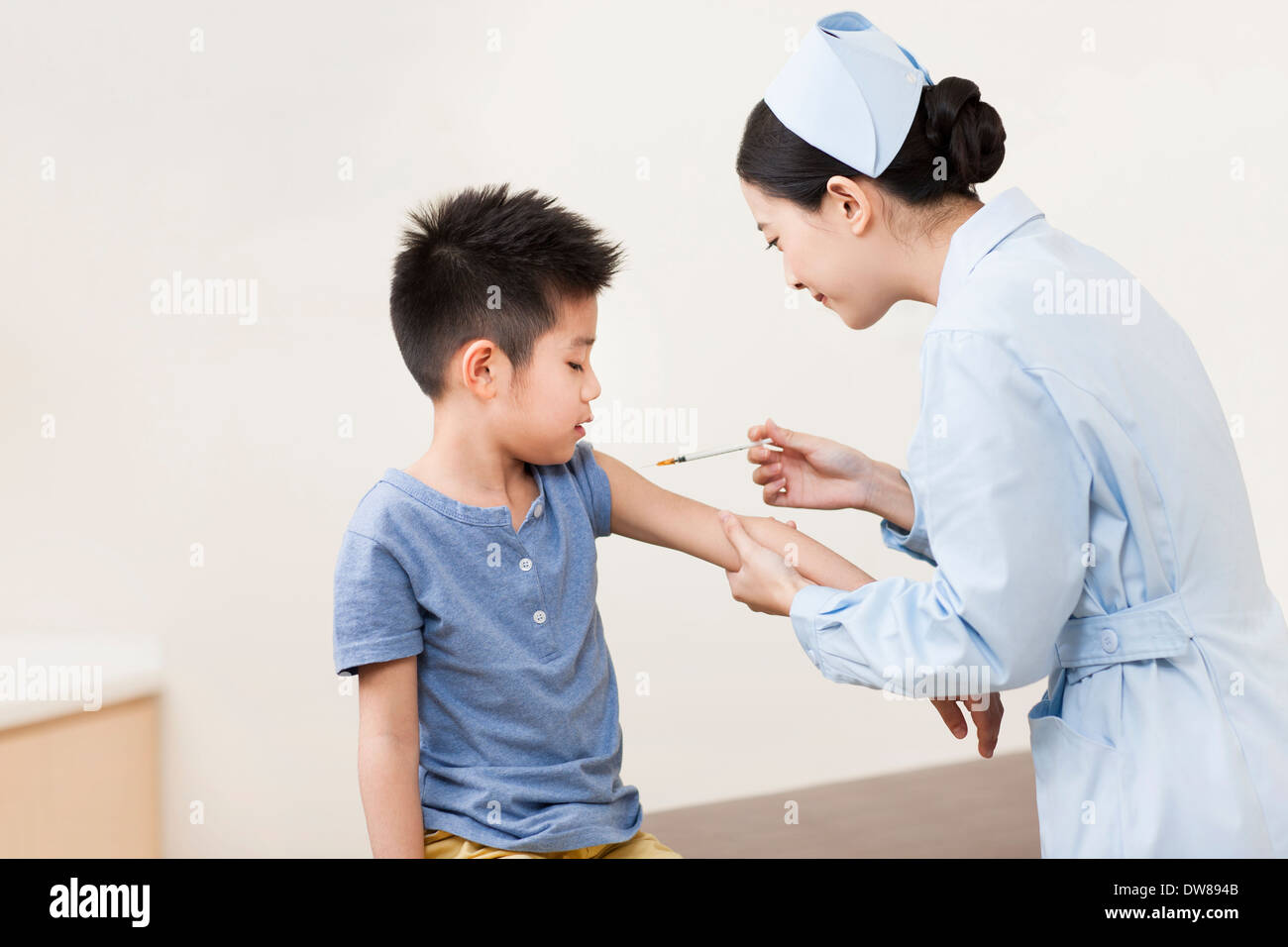 Nurse giving boy injection Stock Photo - Alamy