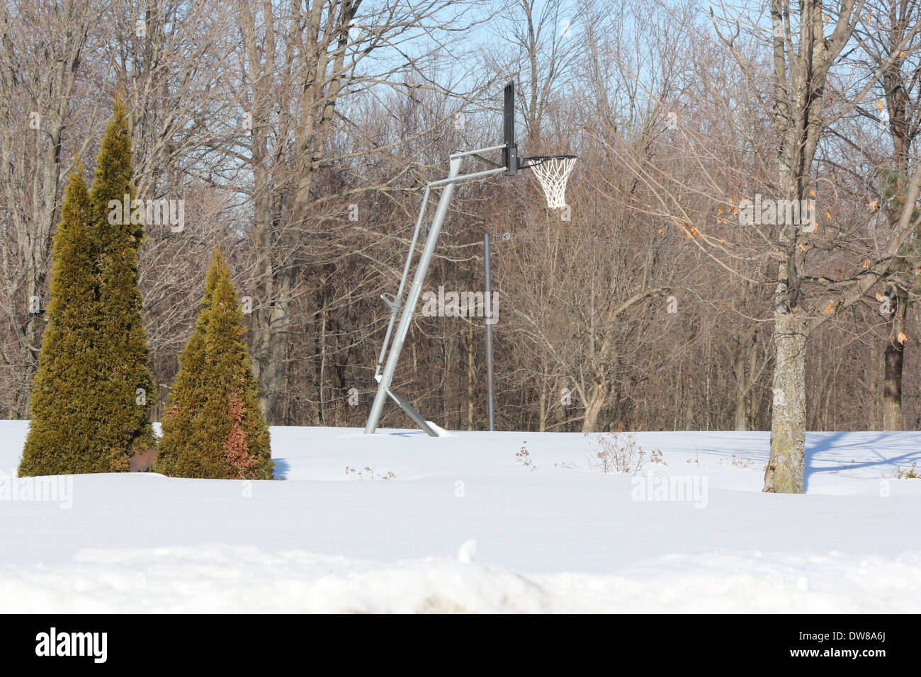 Basketball stand and net on a court outside covered with snow Stock ...