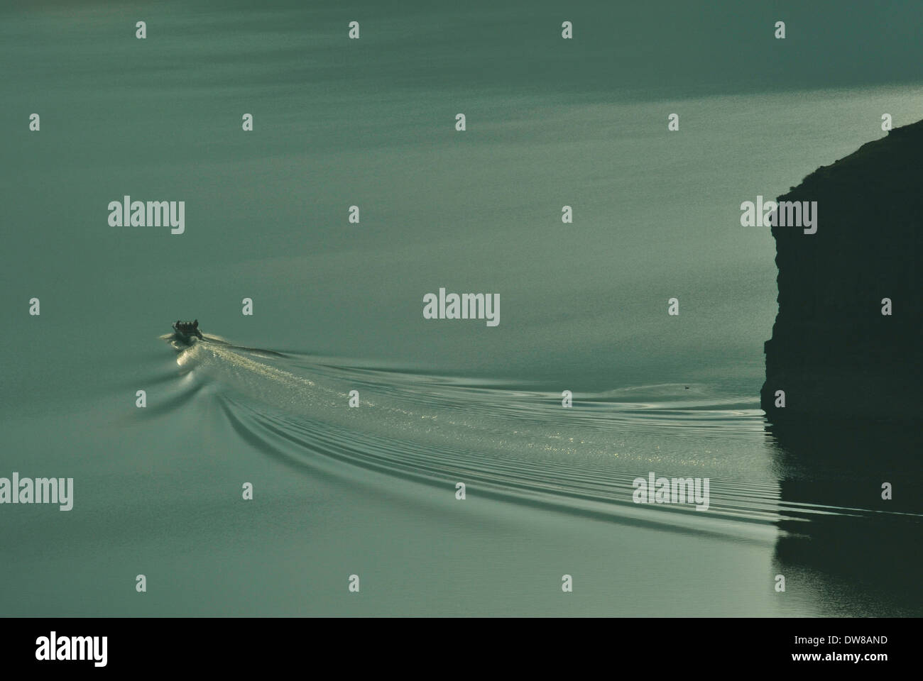 Katse, Lesotho, boat cruising on calm water of Katze dam, landscape ...