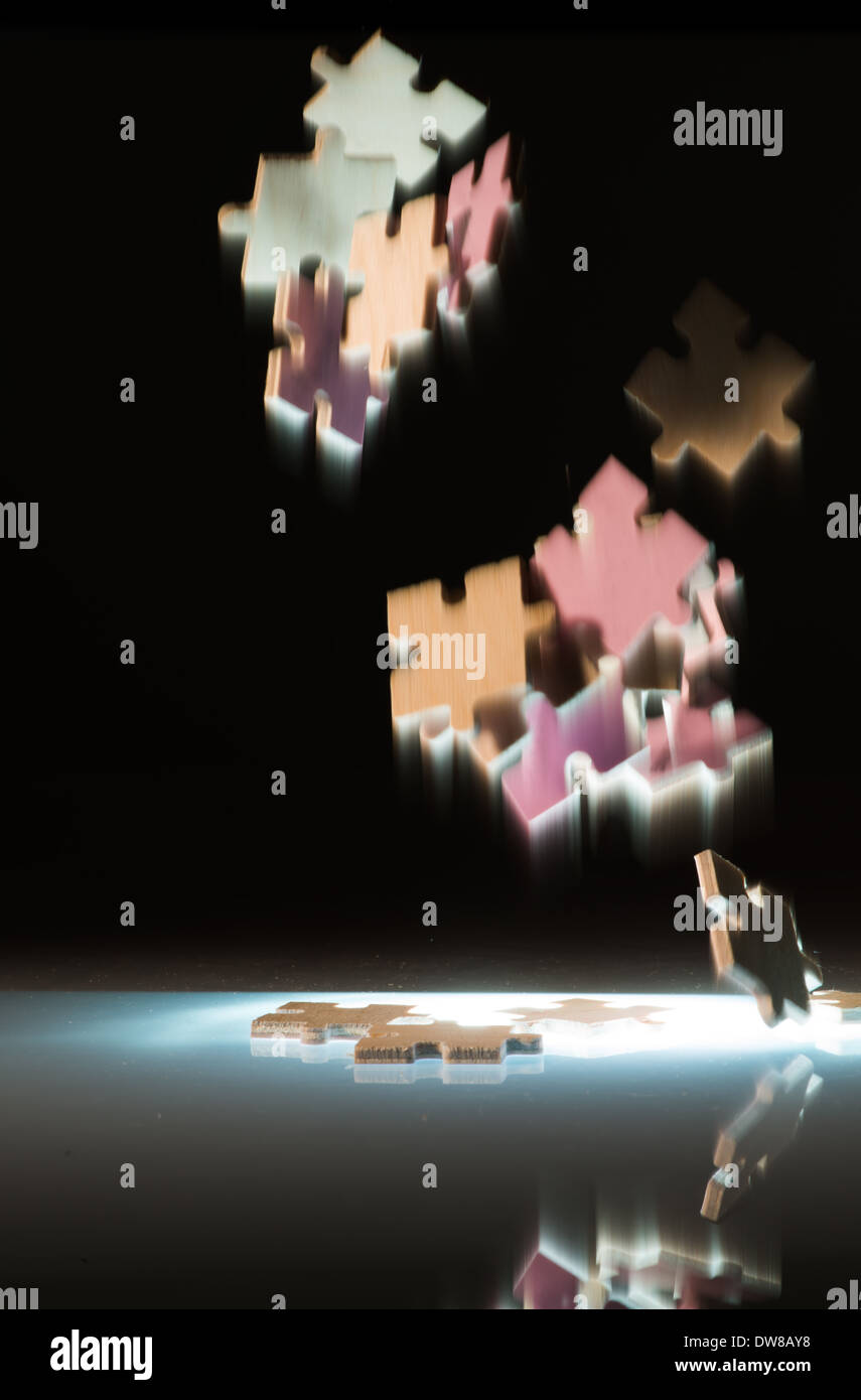 Falling puzzle pieces.Backlight background Stock Photo - Alamy