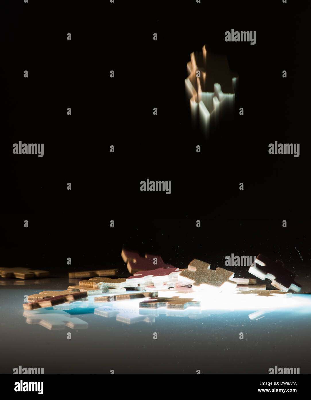 Falling puzzle pieces.Backlight background Stock Photo - Alamy