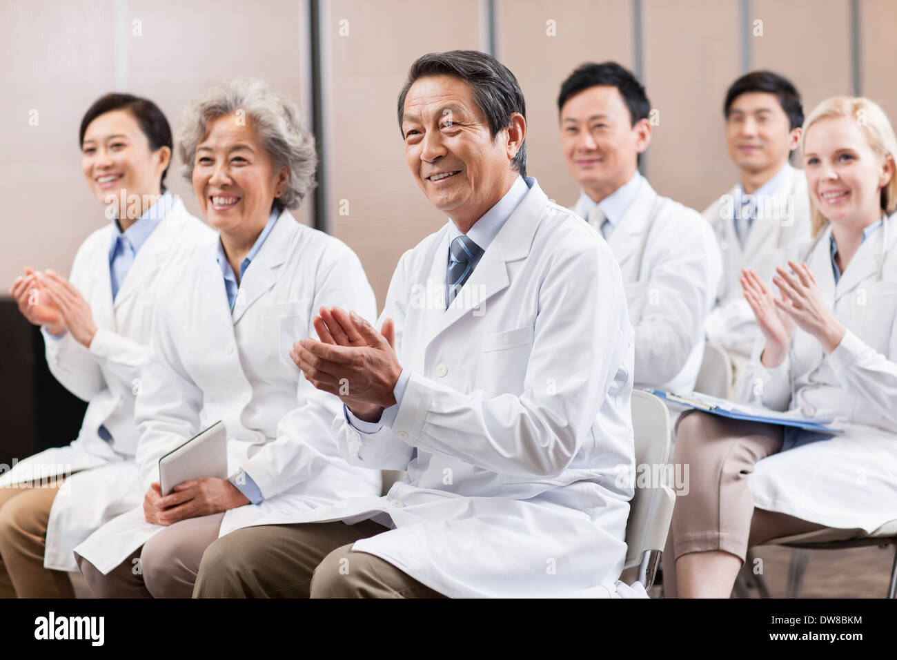 Medical workers clapping in a meeting Stock Photo - Alamy